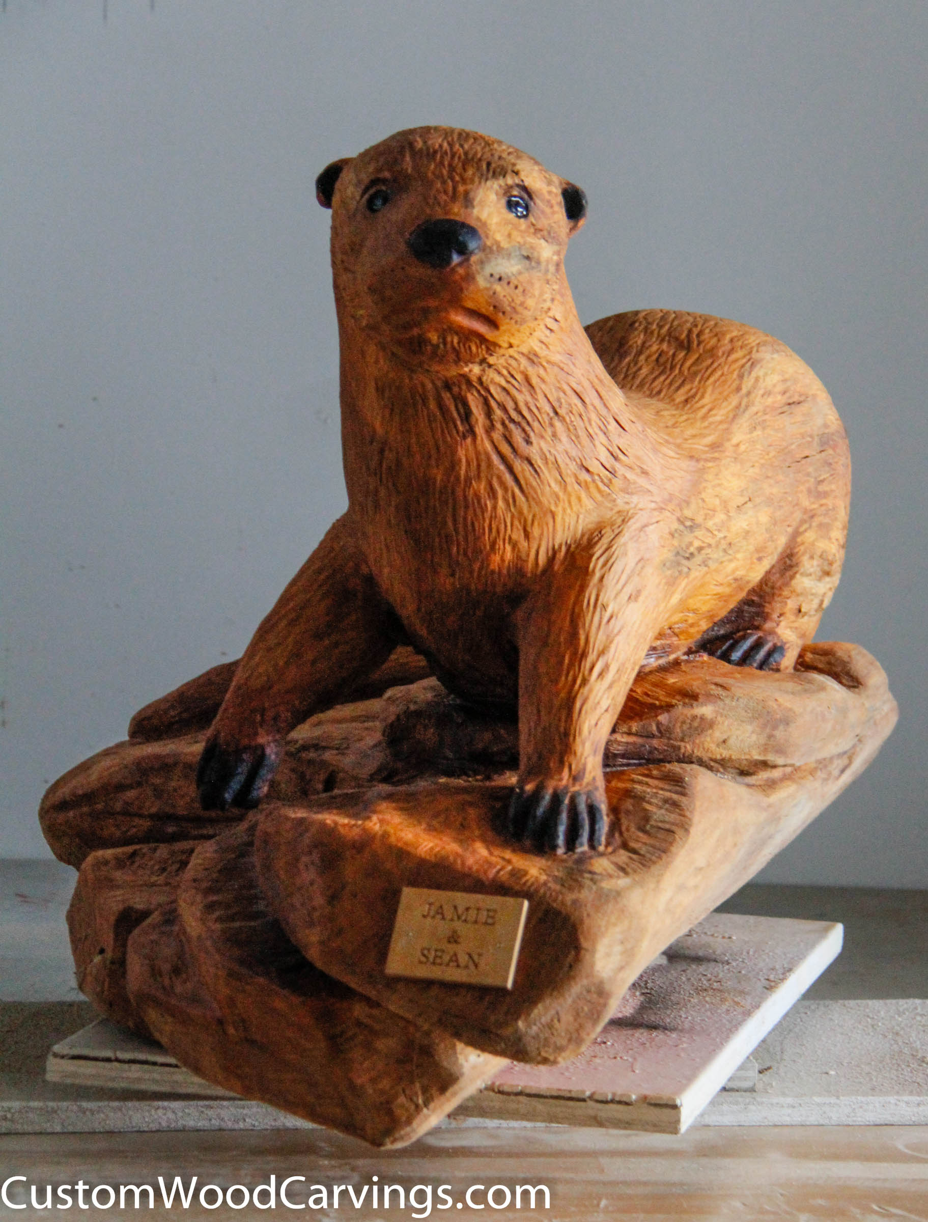 Playful Otter Carving - Custom Sculpture & Sign Company