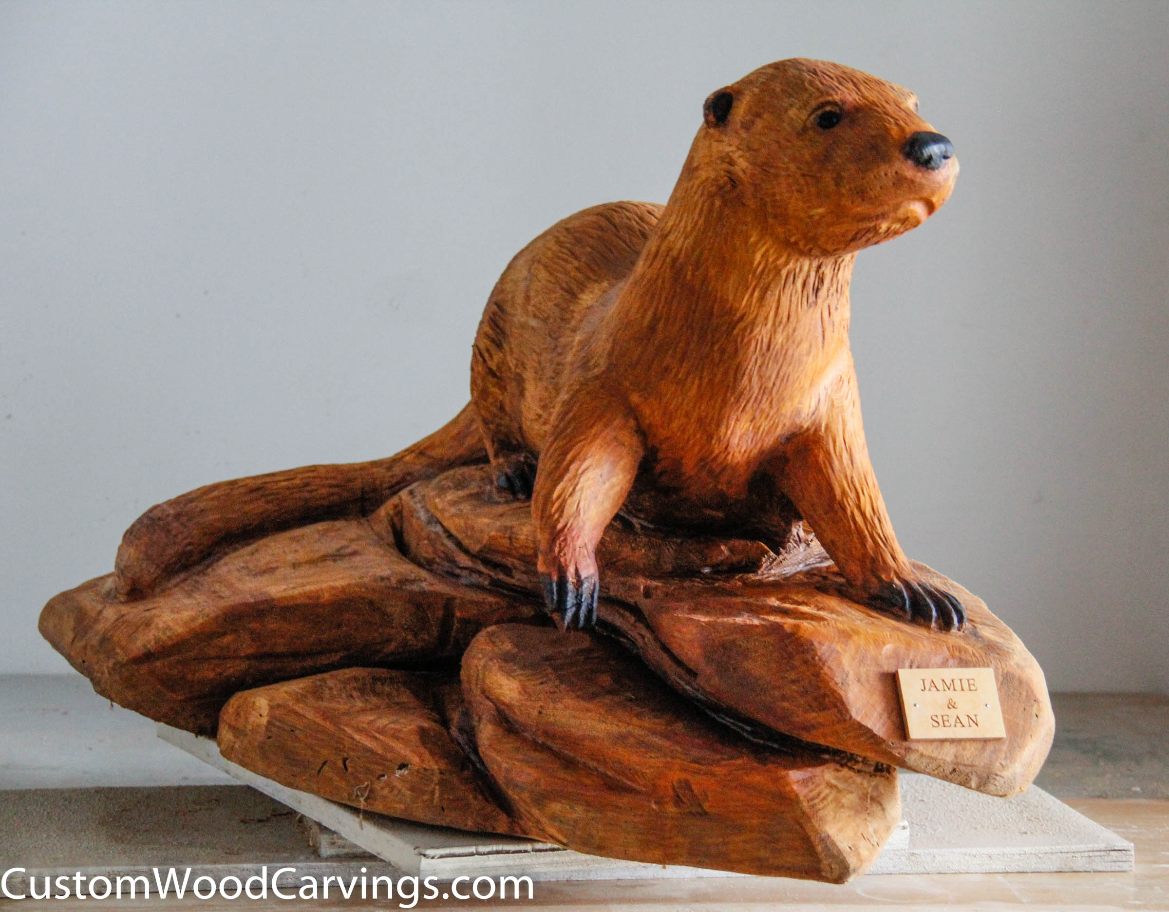 Playful Otter Carving - Custom Sculpture & Sign Company