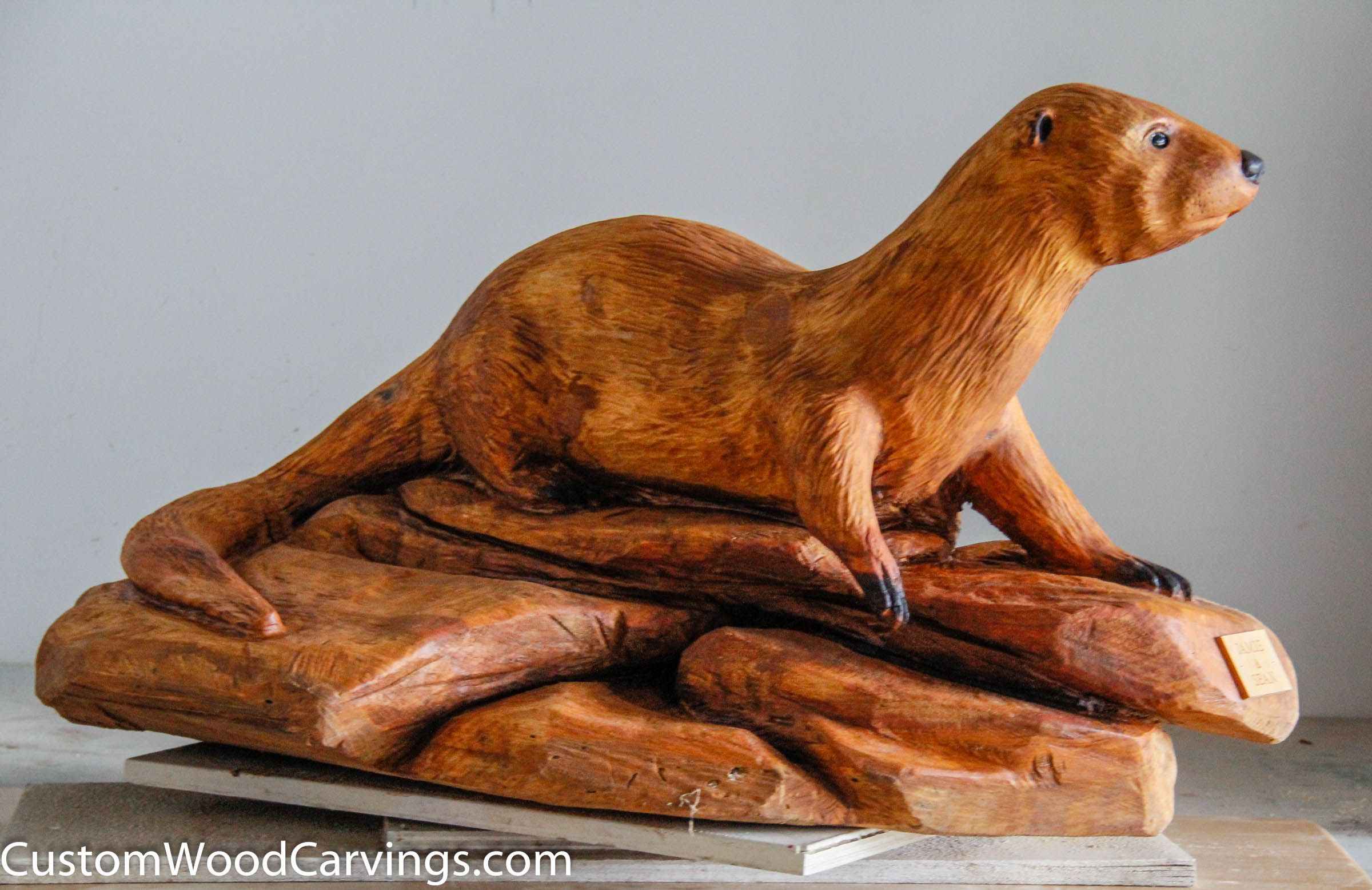 Playful Otter Carving - Custom Sculpture & Sign Company