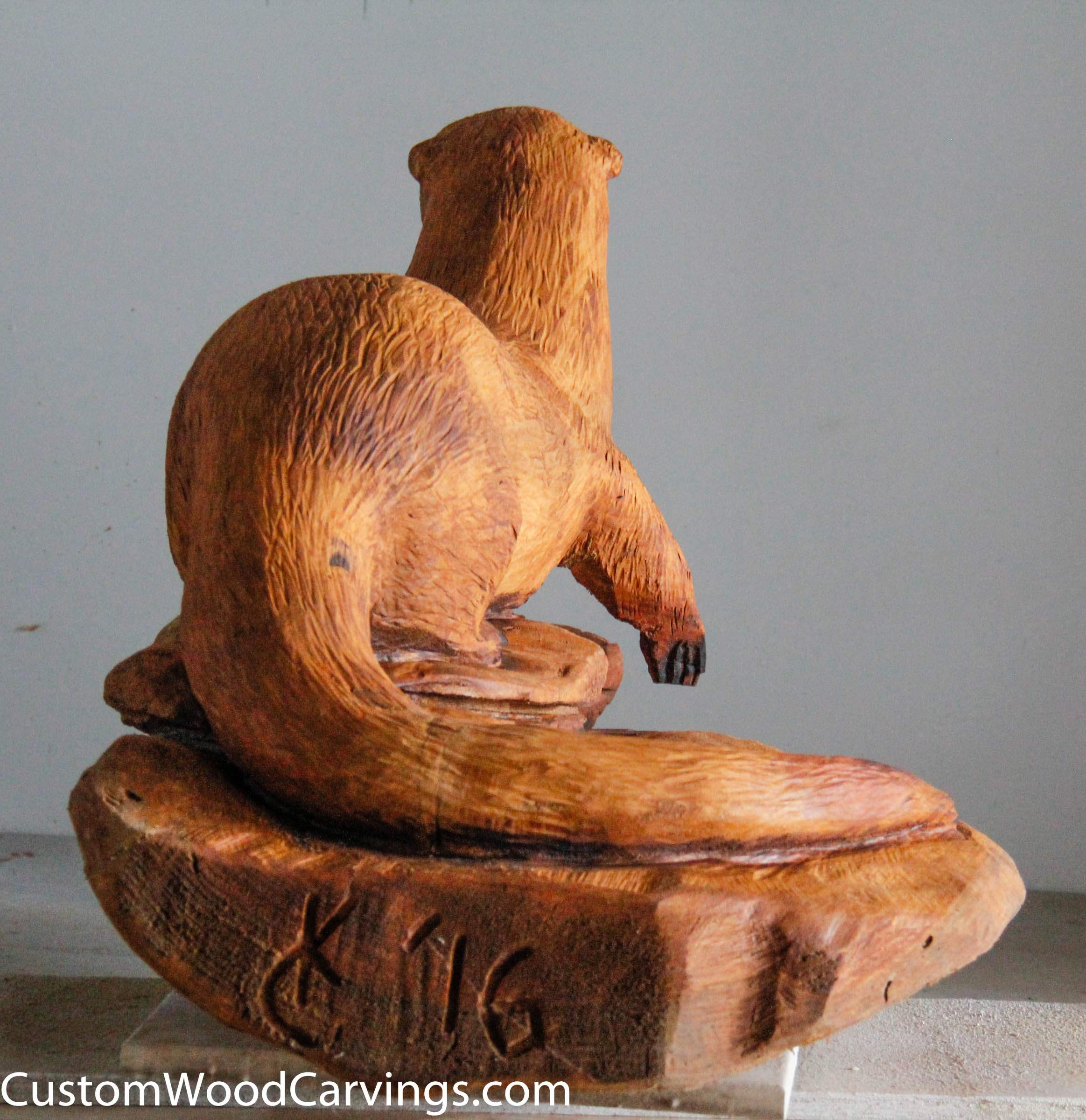 Playful Otter Carving - Custom Sculpture & Sign Company