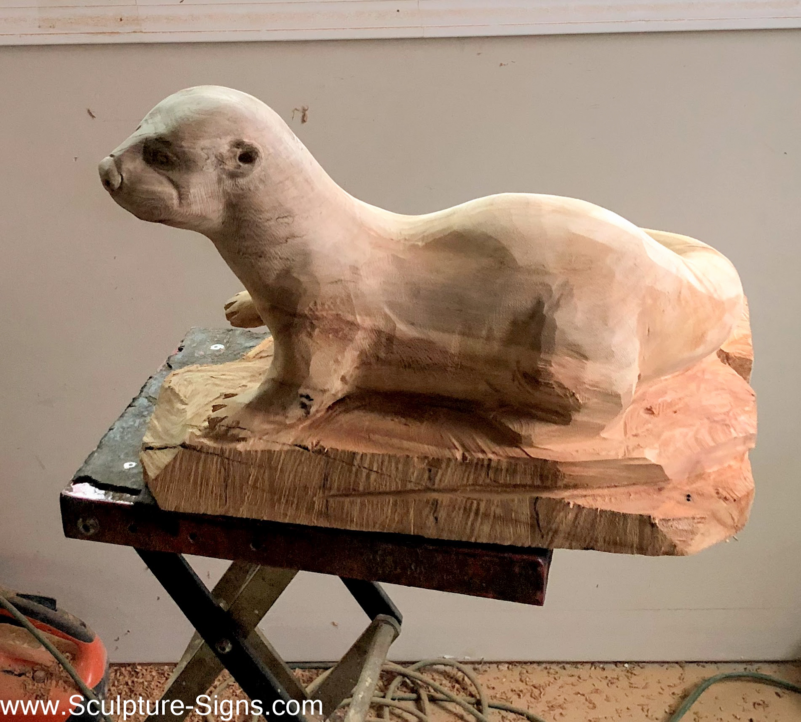 Sycamore Playful Otter Carving - Custom Sculpture & Sign Company